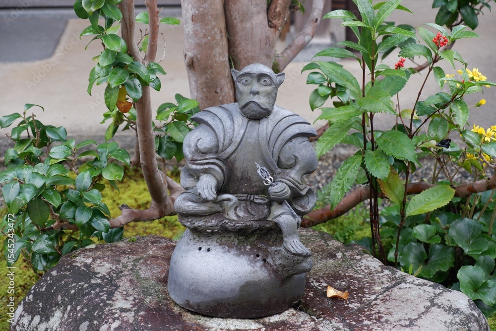 Monk monkey statue in the garden of Saikyo-ji Buddhist temple in Shiga ...