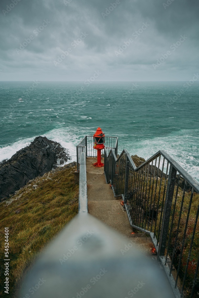 Narrow pathway on a cliff in the water in Mizen Head Signal Station ...