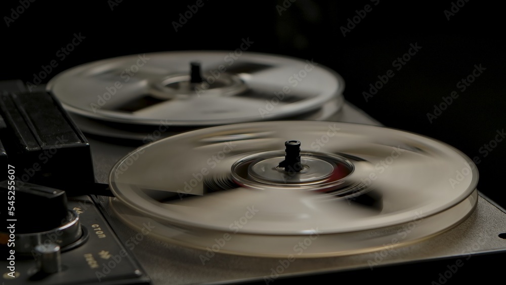 Vintage professional analog reel to reel tape recorder on black studio ...
