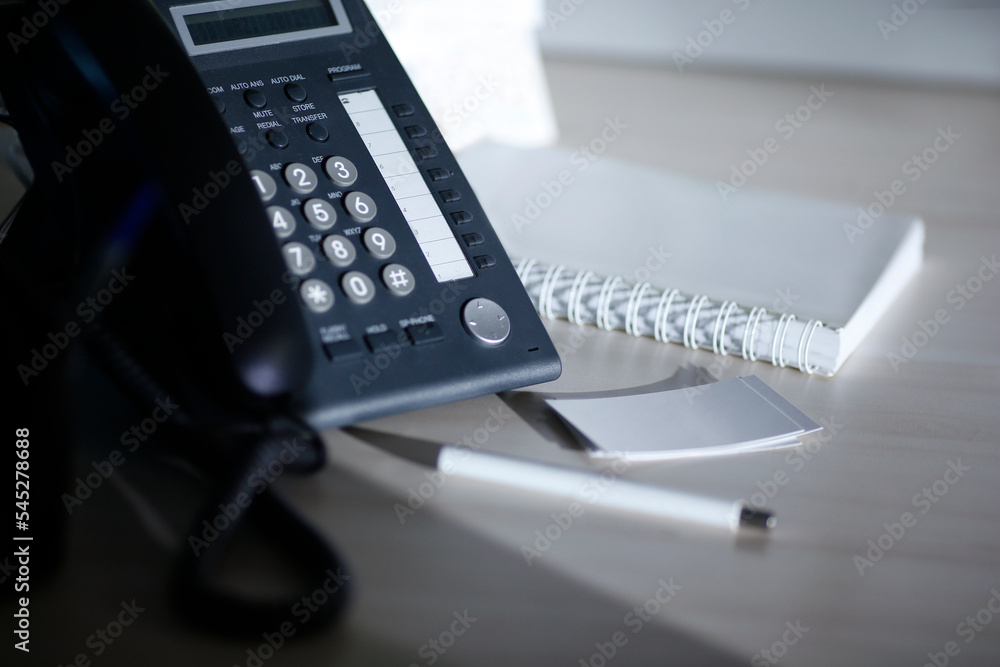 Graphite telephone on the office desk with white pen, clean name cards ...