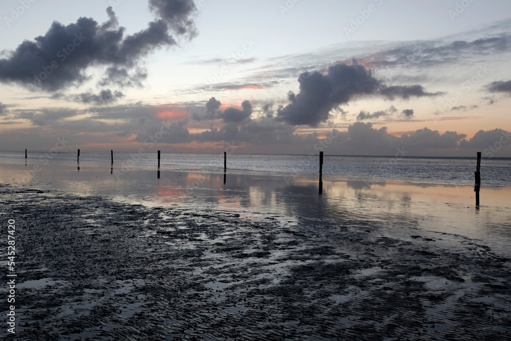 North Sea beach with tides, breakwaters, groynes and pastel sunset ...