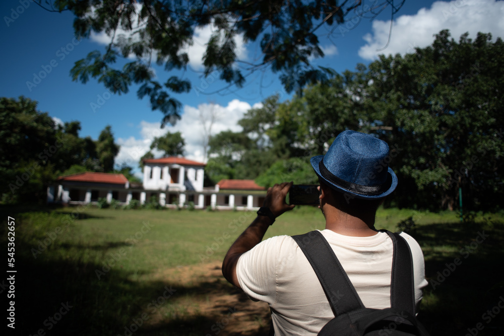 man capturing architecture in jungle by mobile Stock Photo | Adobe Stock