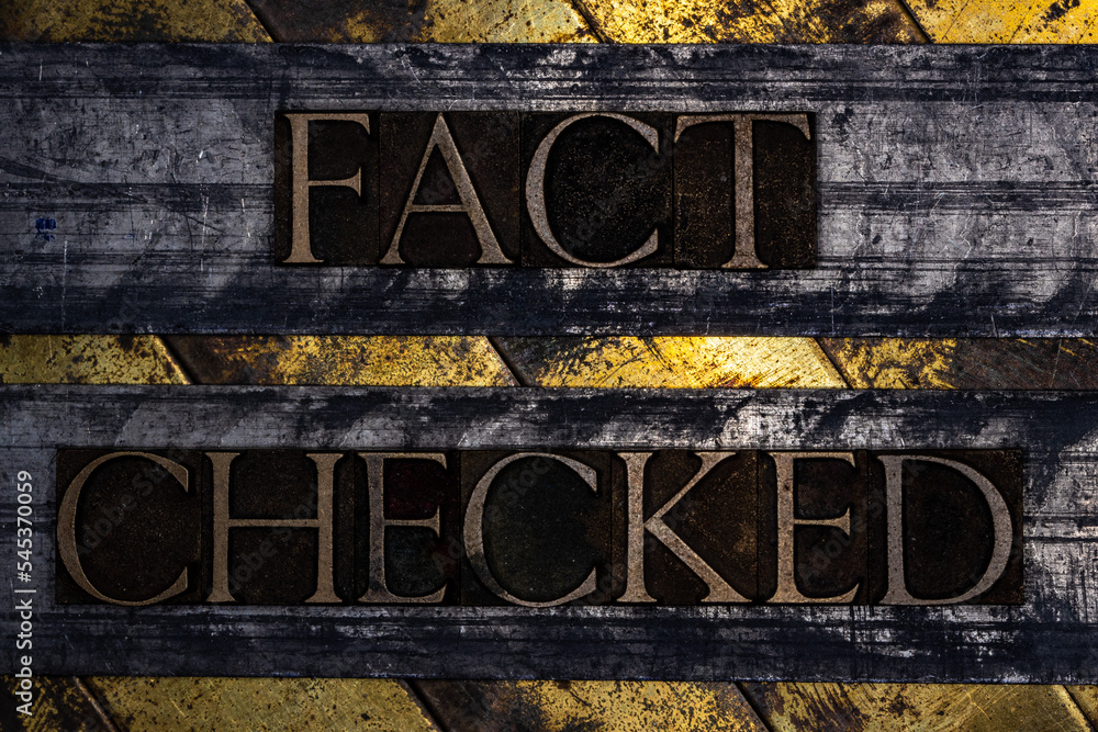 Fact Checked text with on grunge textured copper and gold background ...