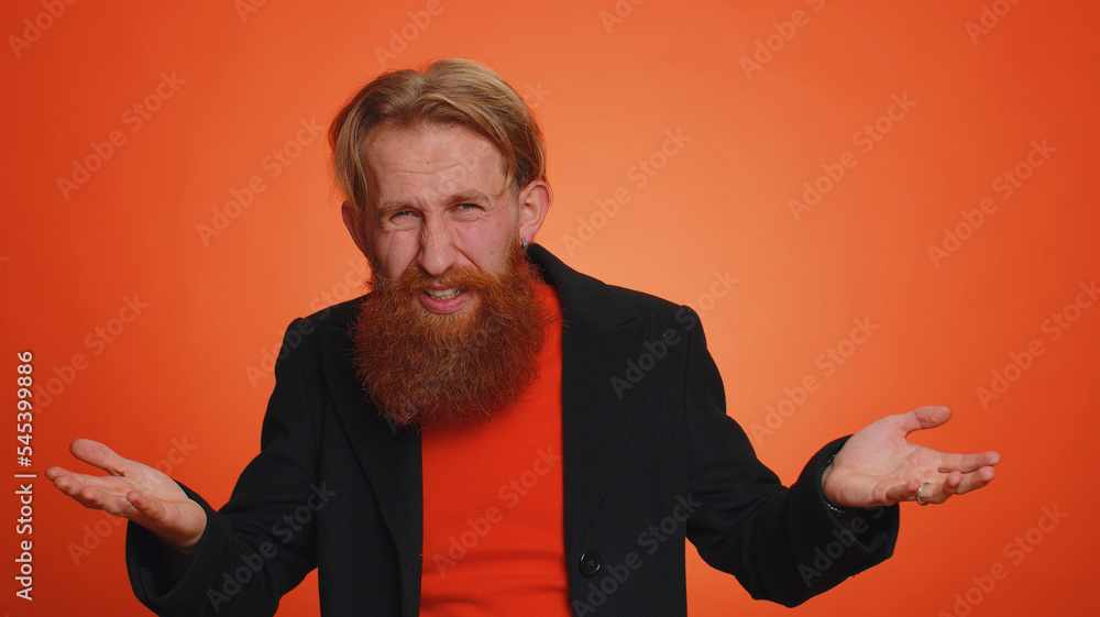 What Why. Sincere irritated redhead man raising hands in indignant ...