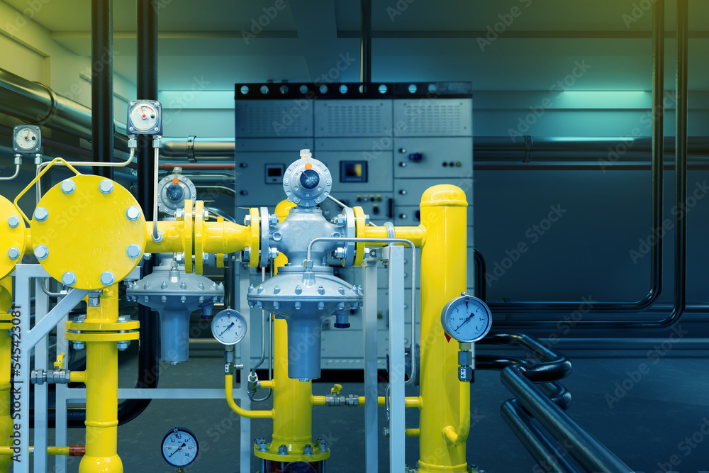 Factory pipes and control unit. Industrial building interior. Room with ...