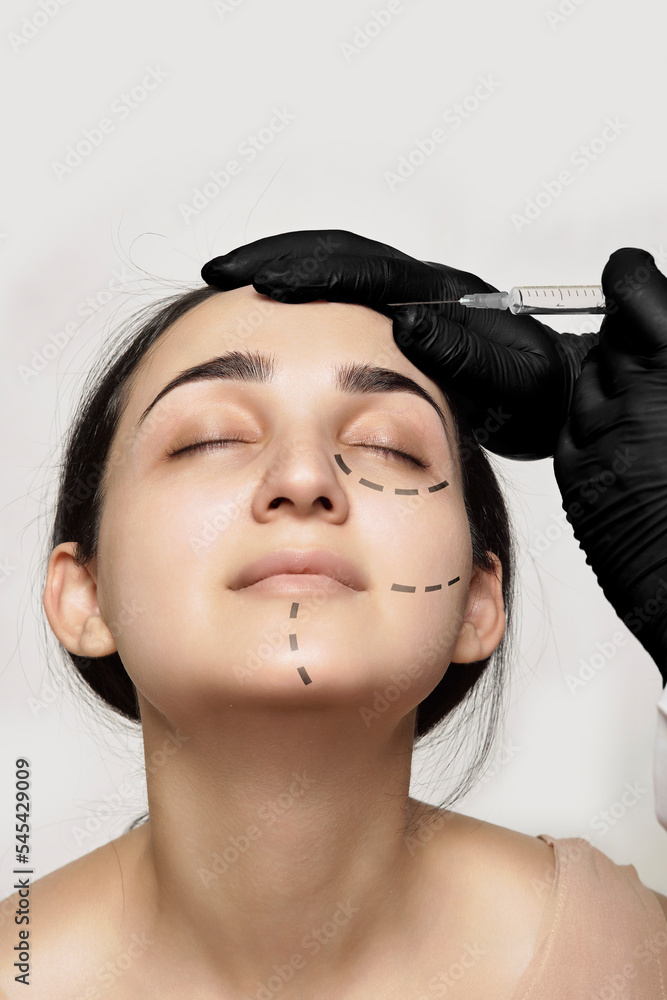 a woman's face with lines drawn on her cheeks and eyebrows, being ...