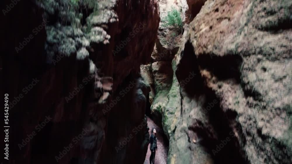 Cave exploration, exploring a cavern. Young woman explorer walks ...