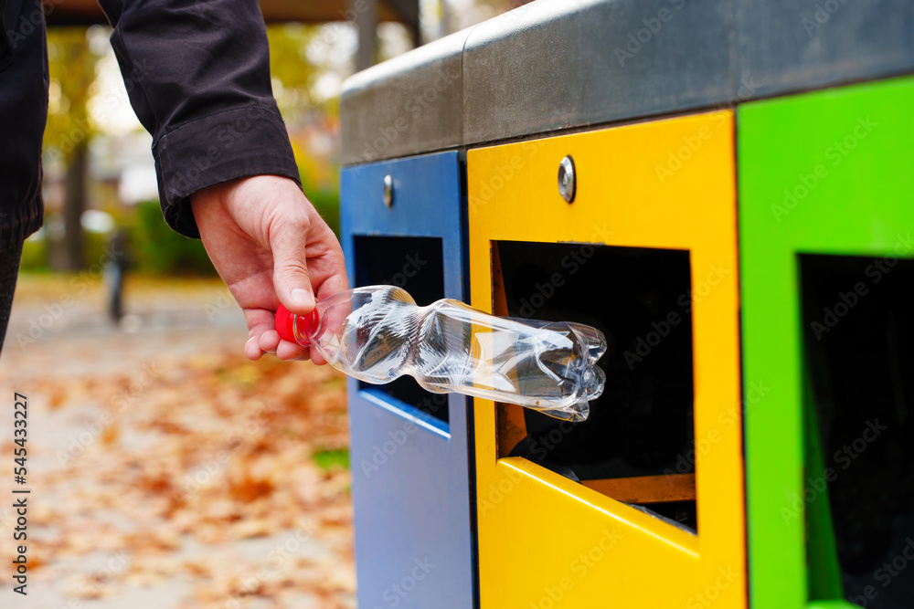 Using waste recycling bins in the public park Stock Photo | Adobe Stock