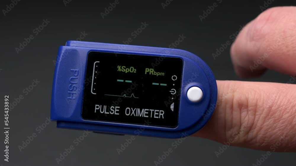 Pulse Oximeter being put on a right hand index finger indicating good ...
