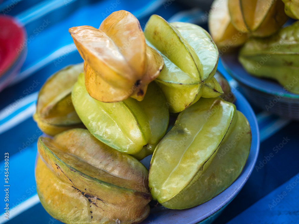 Star fruits also known as Averrhoa Carambola on a plate for sale at the ...