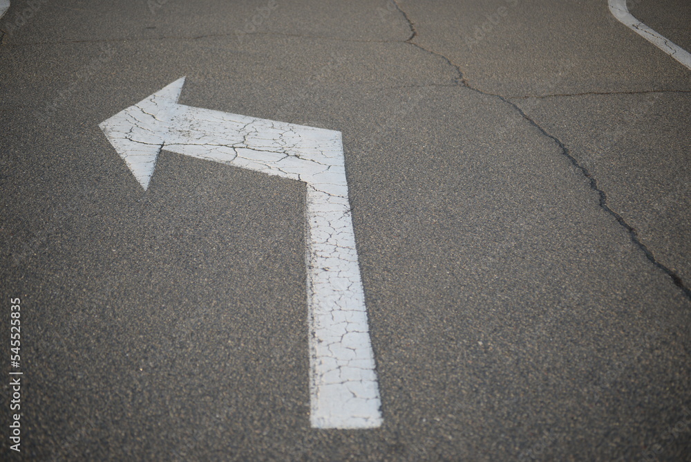 white arrow direction of movement on the road, white arrow on gray ...