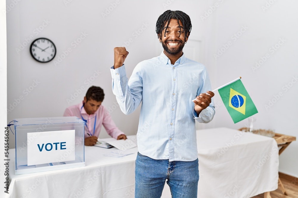 Young hispanic men at political campaign election holding brazil flag ...