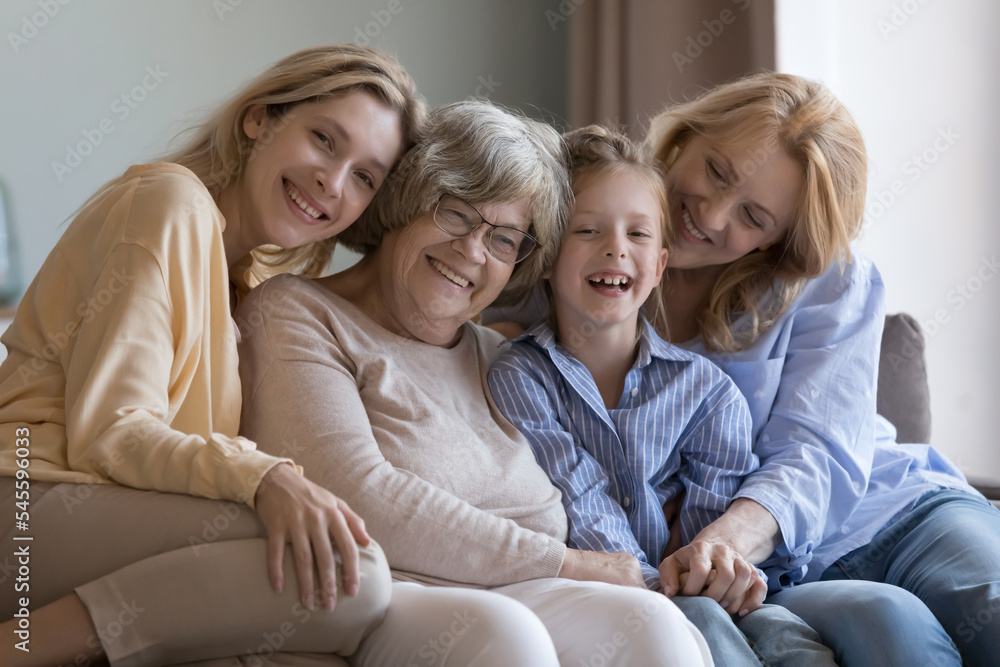Happy multi-generational women dynasty posing for photo at home. Little ...