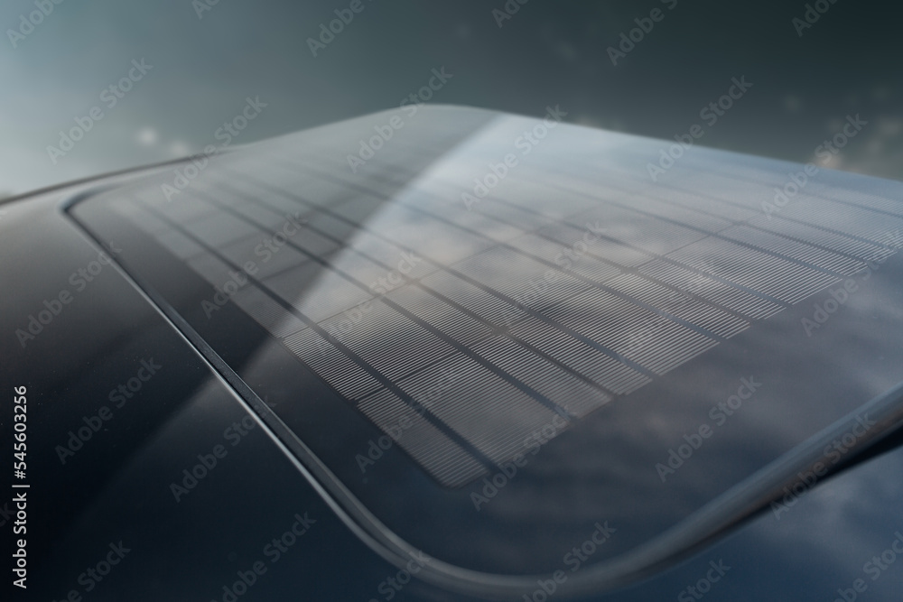Ecological green car with solar panels on a roof. Nature green and ...