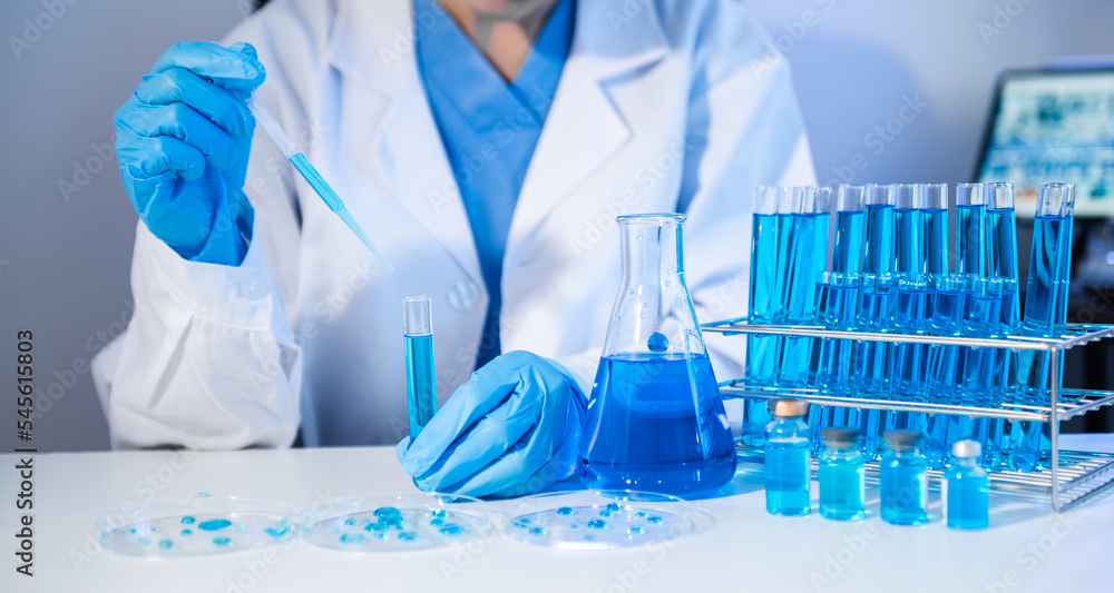 Scientist mixing chemical liquids in the chemistry lab. Researcher ...