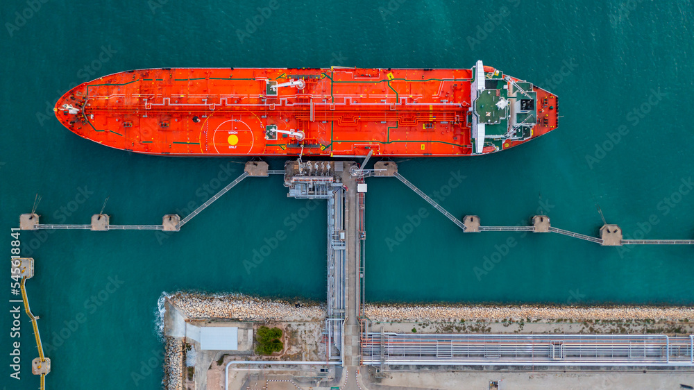 Aerial top view industrial crude oil fuel tanker ship at terminal ...