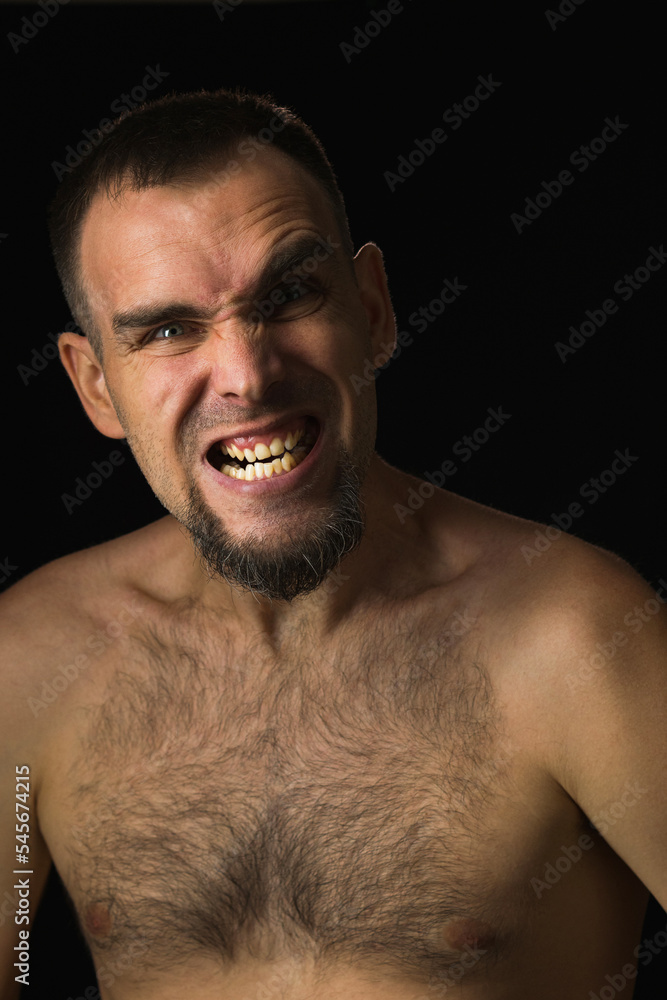 Portrait of an angry man with open mouth and frowning eyebrow ...