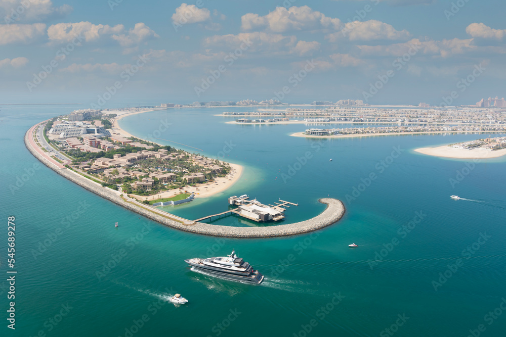 Top view over Dubai palm tree with clear water and, ships and beautiful ...