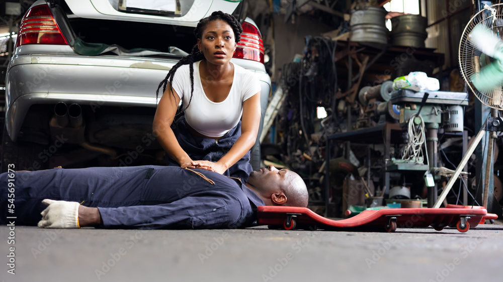 African american female mechanic helping black man with chest pain ...