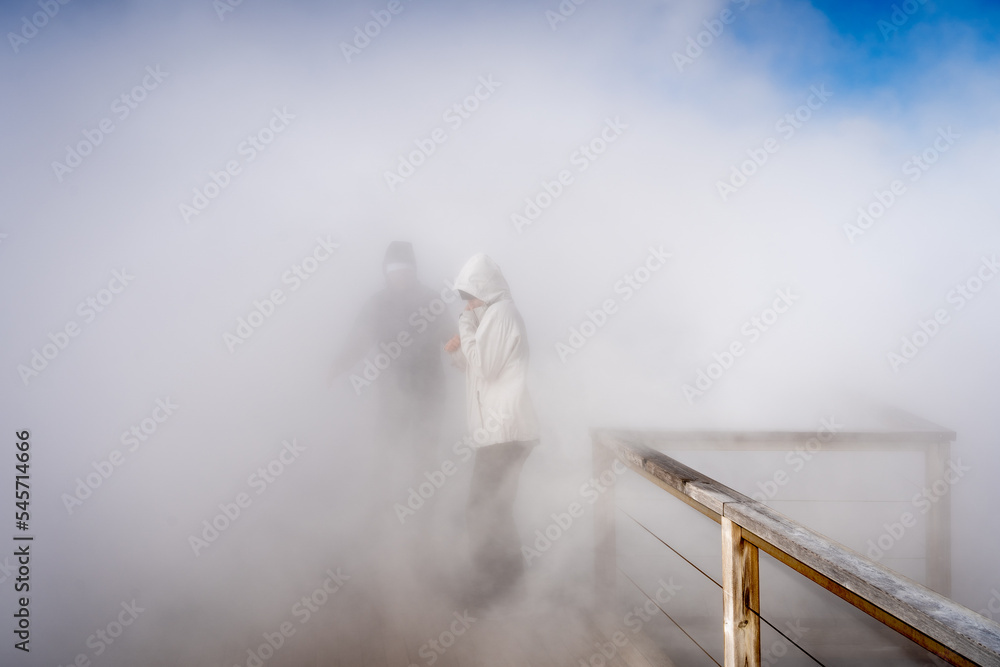 Tourists in sulphur smelly steam at Gunnuhver hot springs at Reykjanes ...