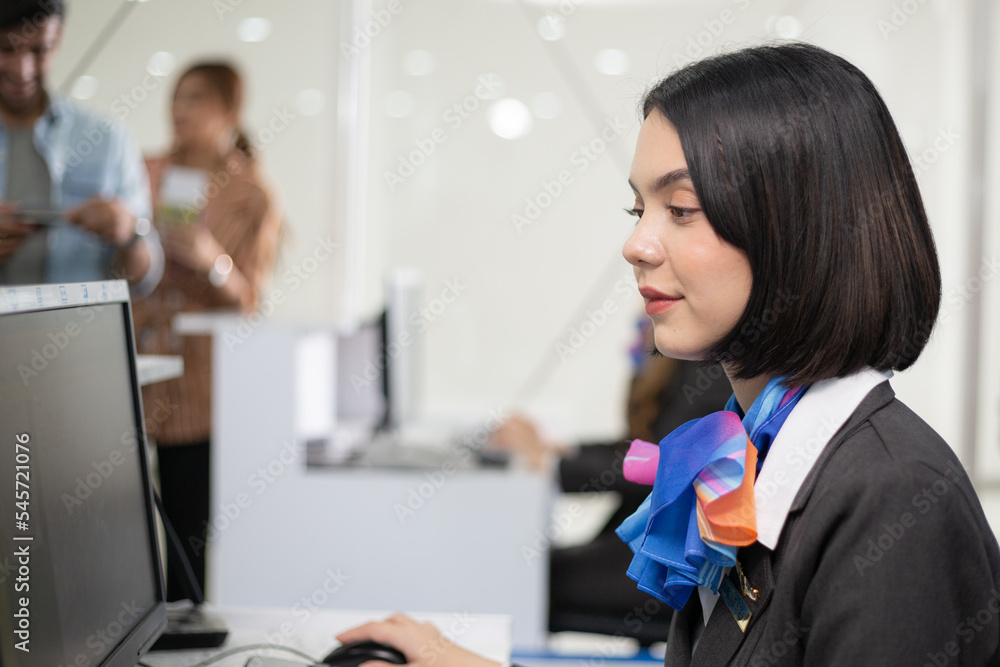Attractive woman officer sitting at check in counter desk at the ...