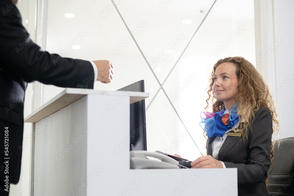 Caucasian female officer working at airline check in counter service at ...