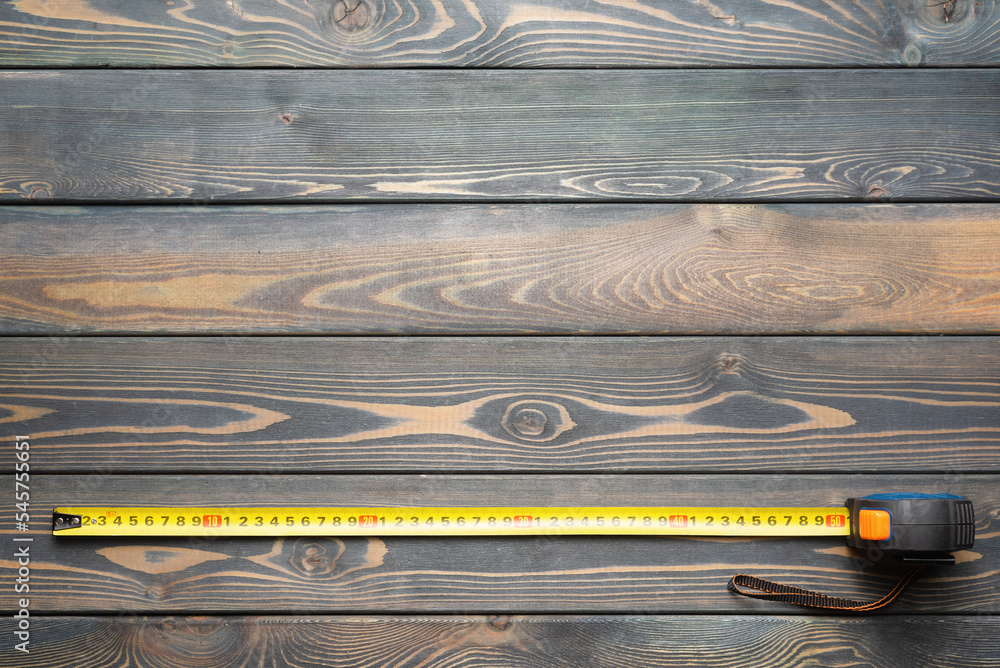 Meter measure tape on wooden workbench background with copy space ...