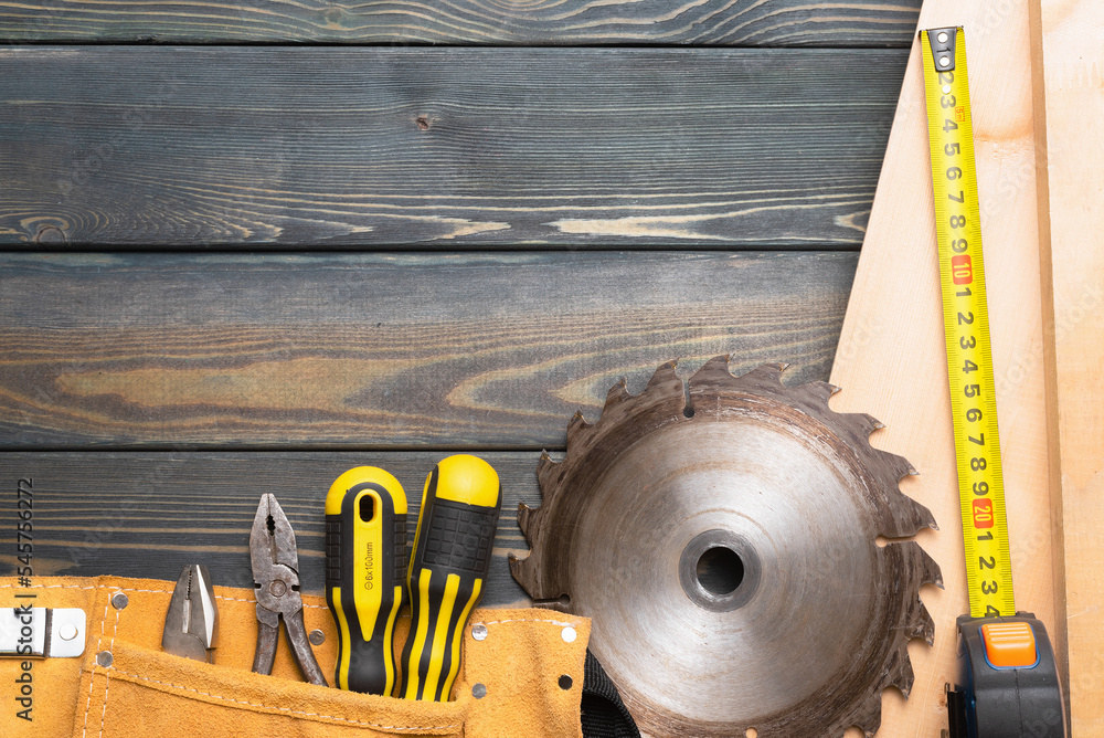 Meter, wooden planks, construction tools and circular saw blade on the ...