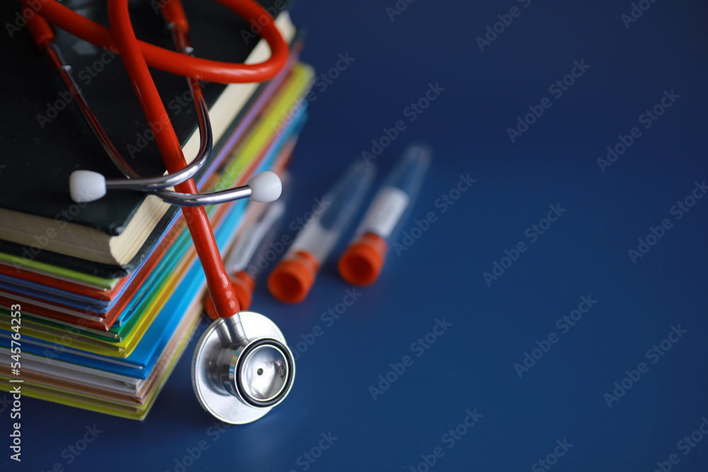 stethoscope on stack of medical guide book for doctor learning ...