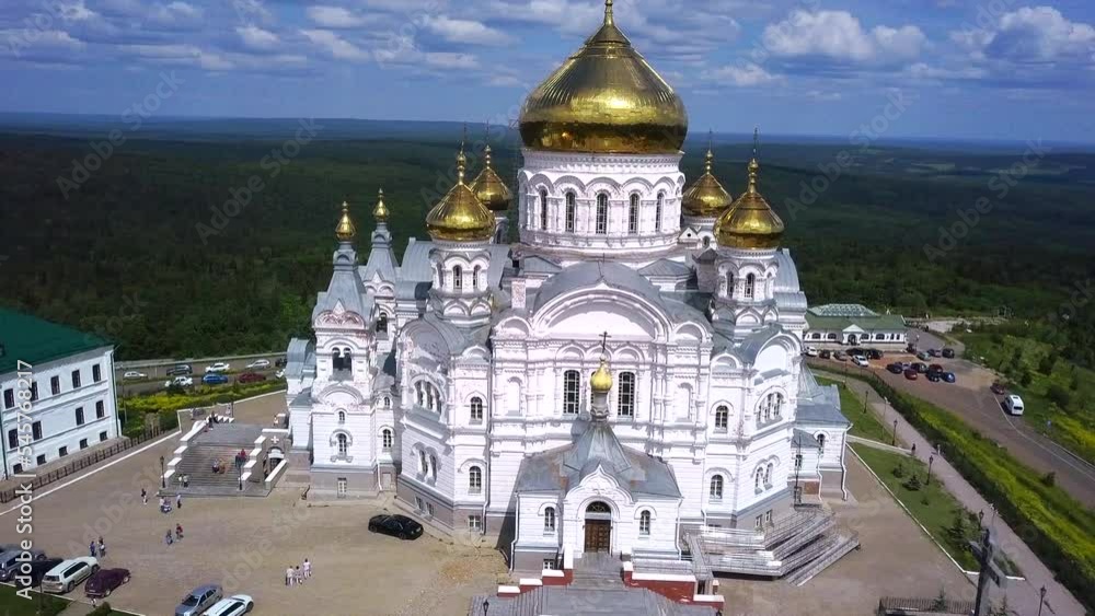 Huge white church. Drone view. Clip. A green landscape with a temple ...