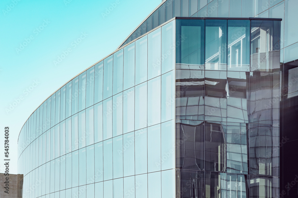 facade of an office building covered in shiny looking steel and glass ...