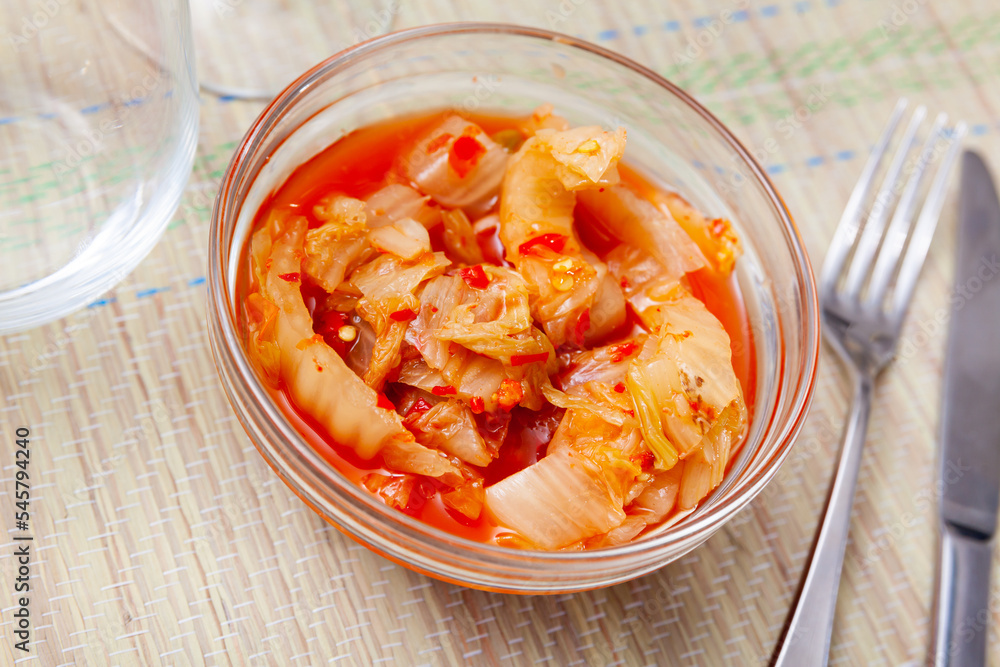 Spicy pickled napa cabbage kimchi with minced habanero in salad bowl ...