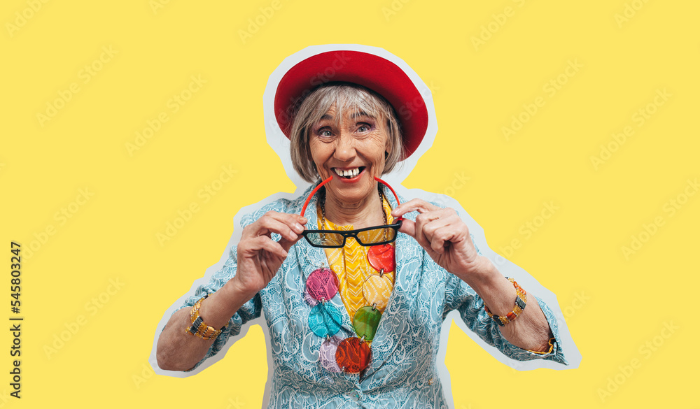 Funny cool old lady dressed in trendy clothes on a colorful studio ...