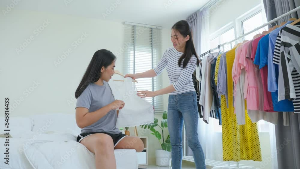 Asian young amputee leg woman and friend choosing clothes on closet ...