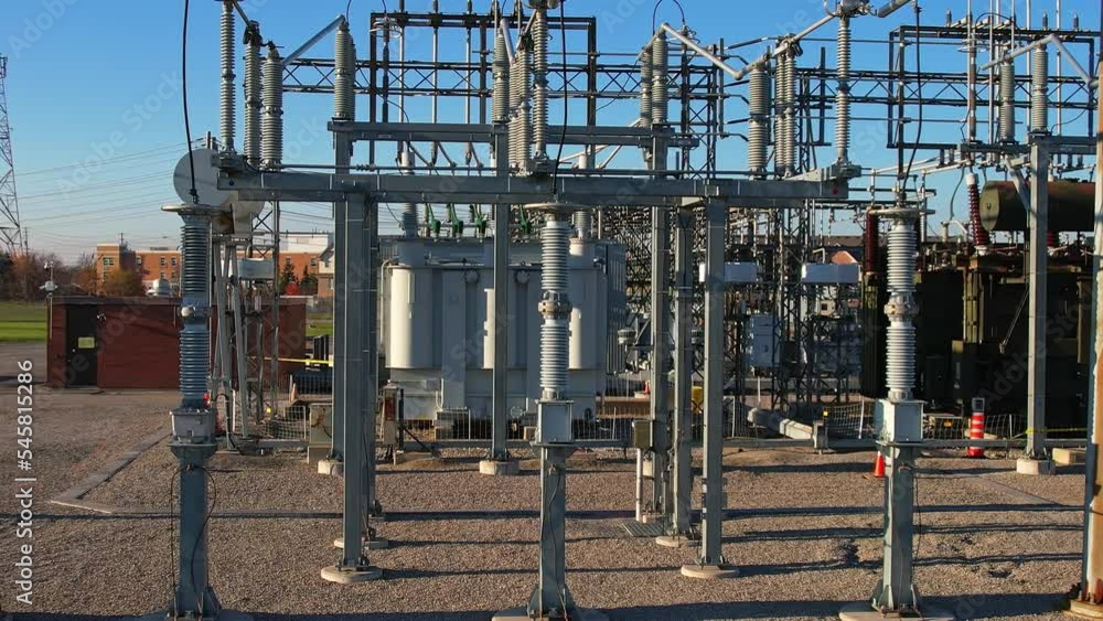 High voltage power grid station. Slow panning. Pylons and high voltage ...