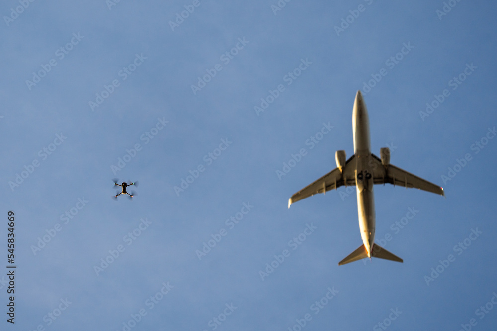 The drone is flying on low height under airplane with flying above the ...