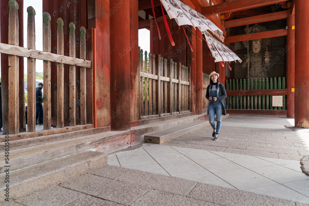 full length of Asian Japanese female tourist looking into distance ...