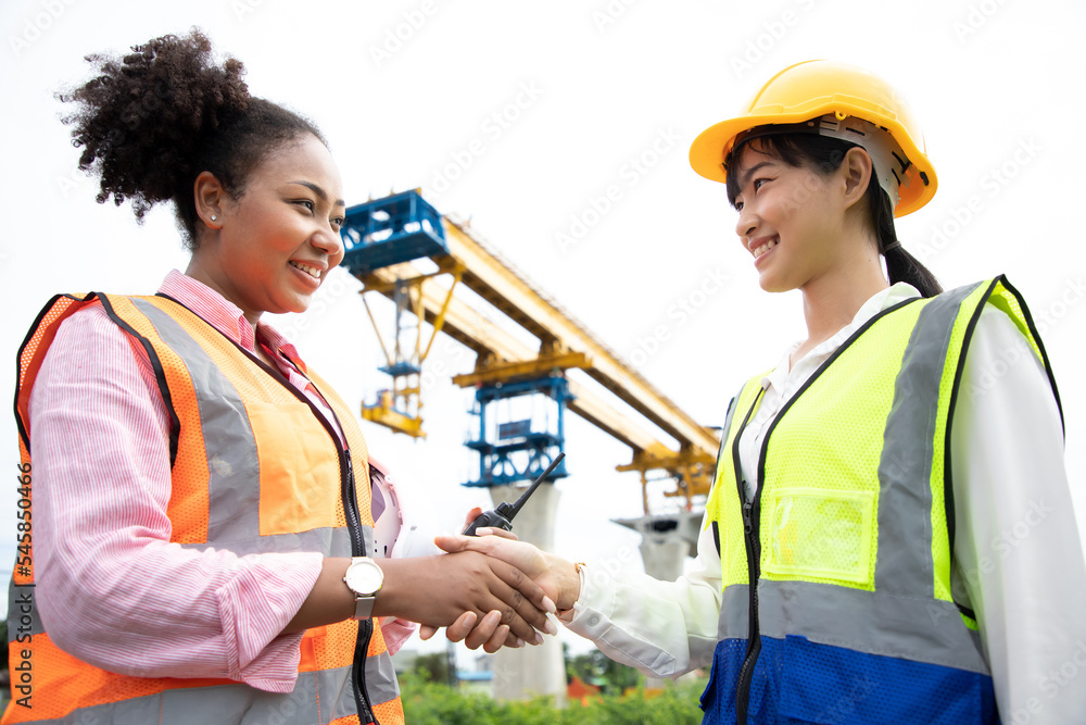 Diversity of architectural engineer woman with assistant plan and ...