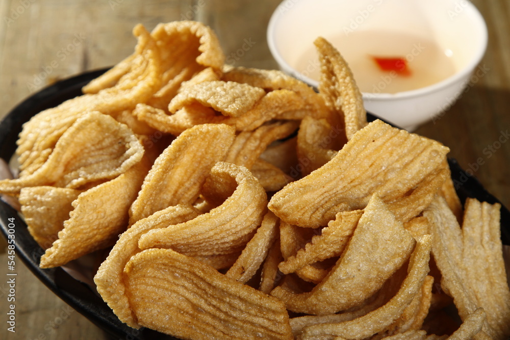 Chicharon, Filipino pickup food, with vinegar sauce dip Stock Photo ...