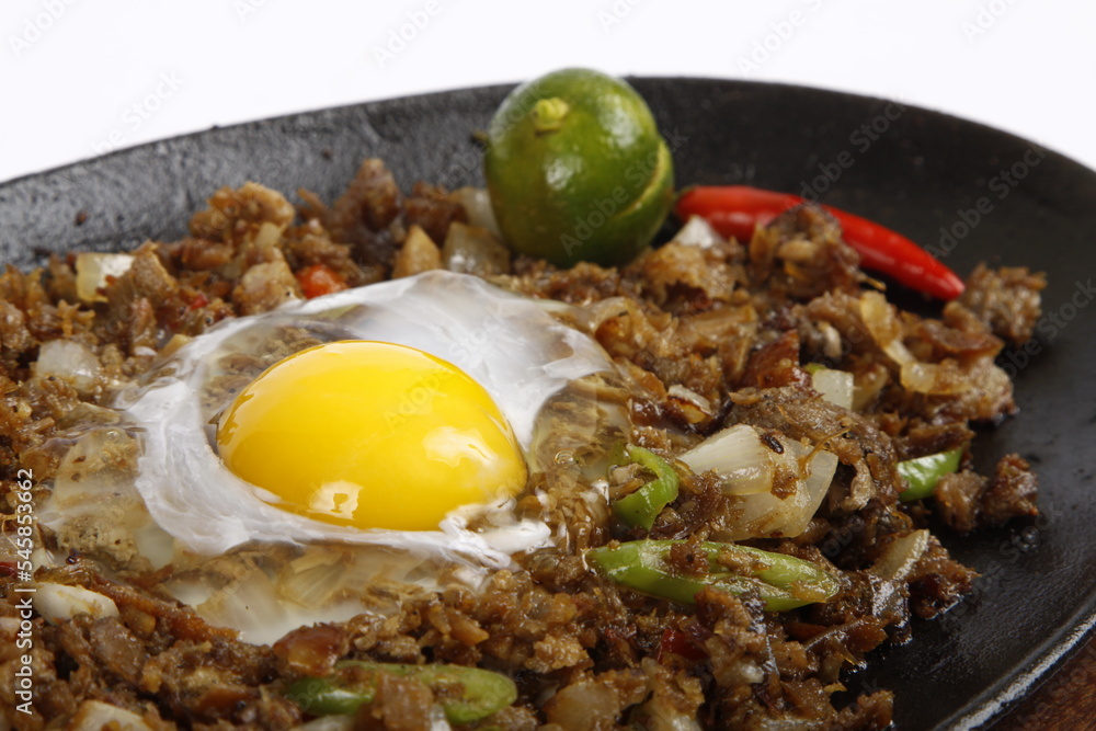 Pork sisig, a Filipino dish, served on a sizzling plate Stock Photo ...