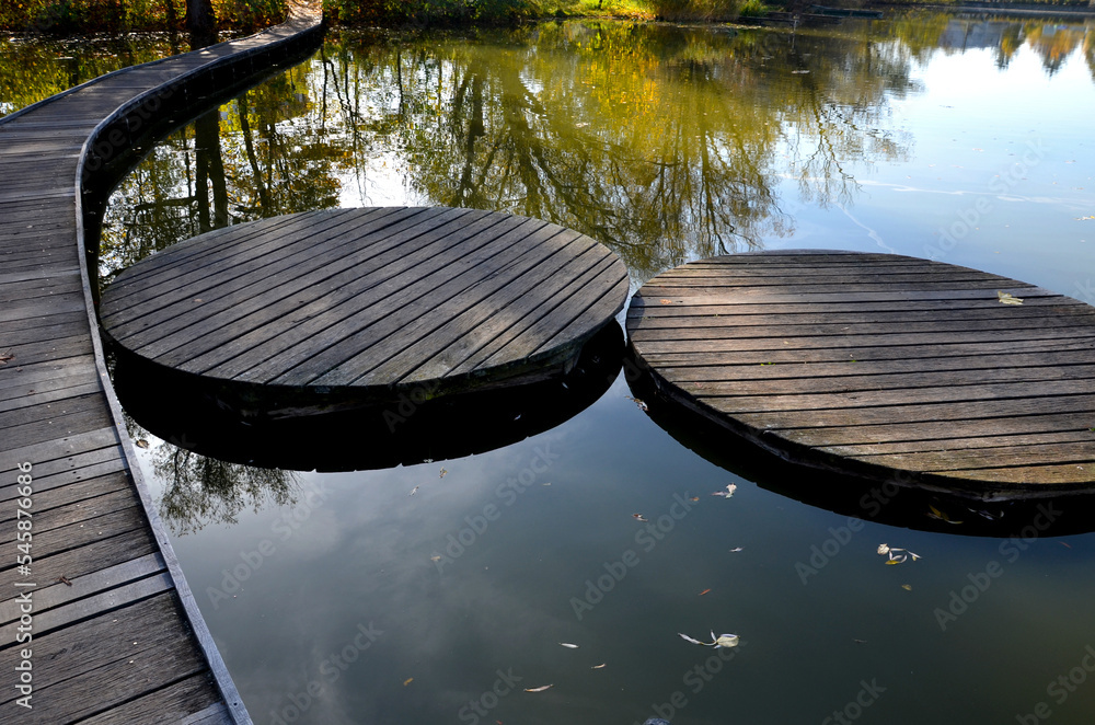 floating walkway made of wooden planks. narrow curved paths on stilts ...