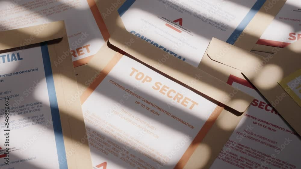 Different types of classified document folders on the floor with window ...