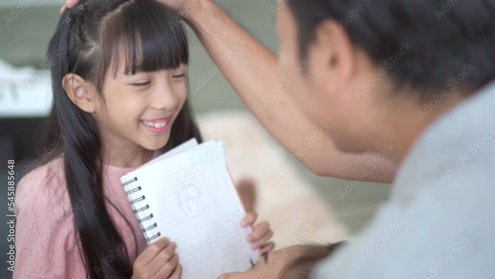 Little girl showing her drawing to parent. Stock Video | Adobe Stock