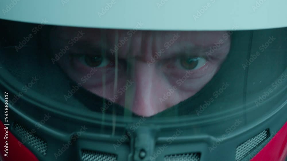 ECU Portrait of sports car driver in protective helmet racing on a ...