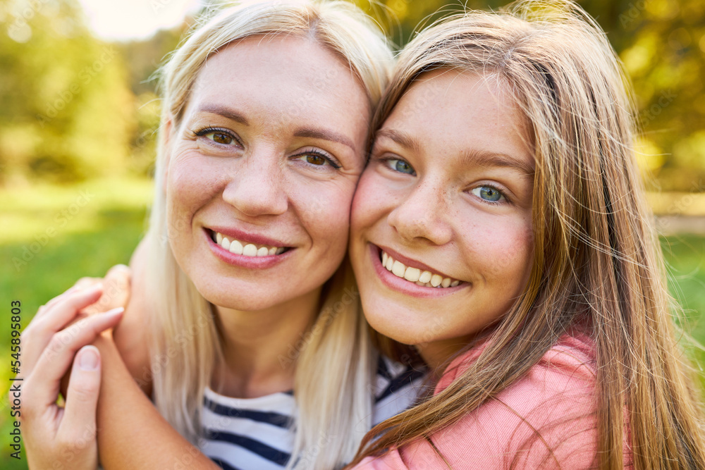 Happy daughter lovingly hugs her mother Stock Photo | Adobe Stock
