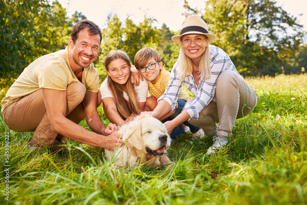 Happy family with two children and dog Stock Photo | Adobe Stock