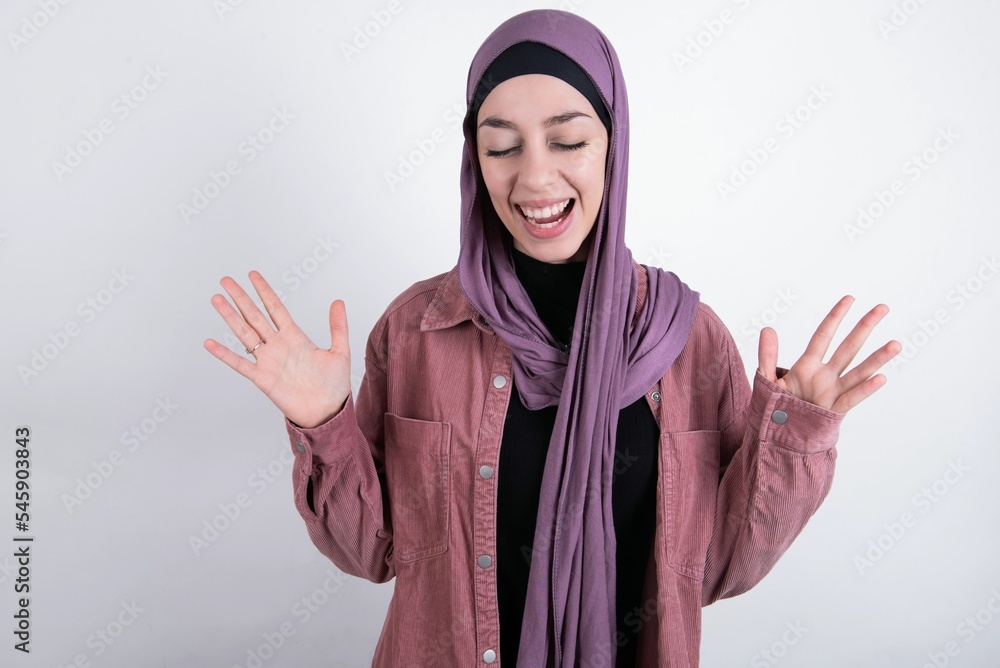 Crazy outraged young beautiful muslim woman wearing hijab and pink ...