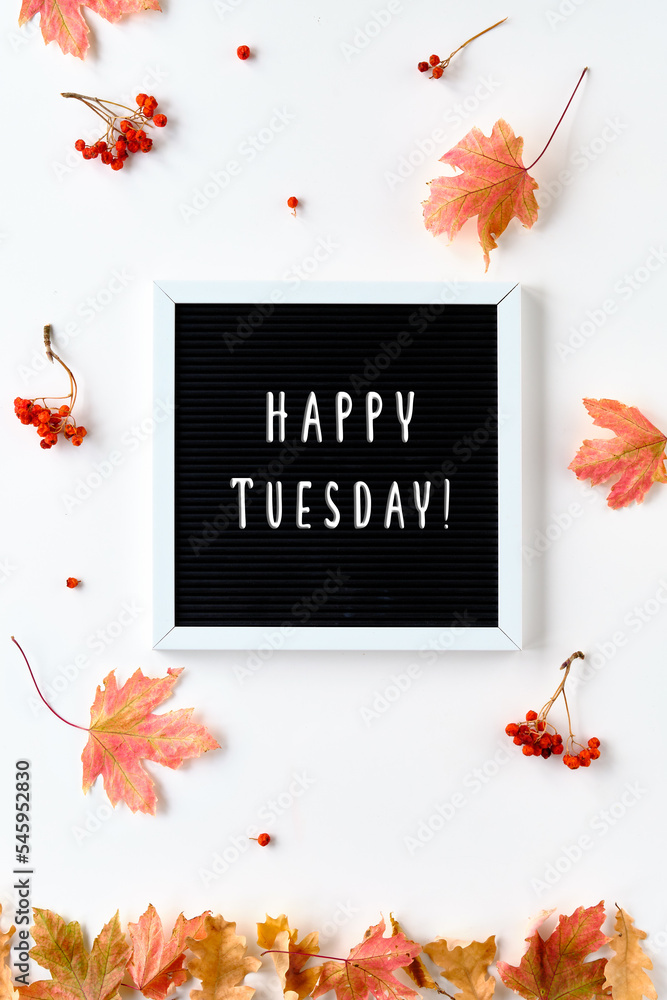 Happy Tuesday greeting text on text board. Autumn leaves, spices and ...