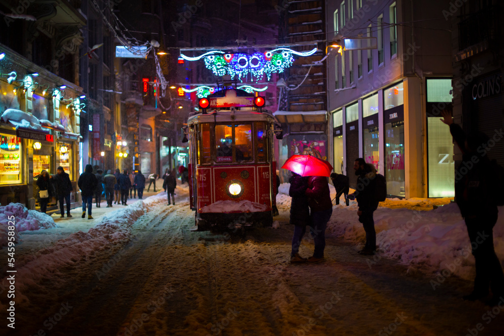 Snowy day in Taksim, Beyoglu. Nostalgic tram in Istiklal Street. Taksim ...