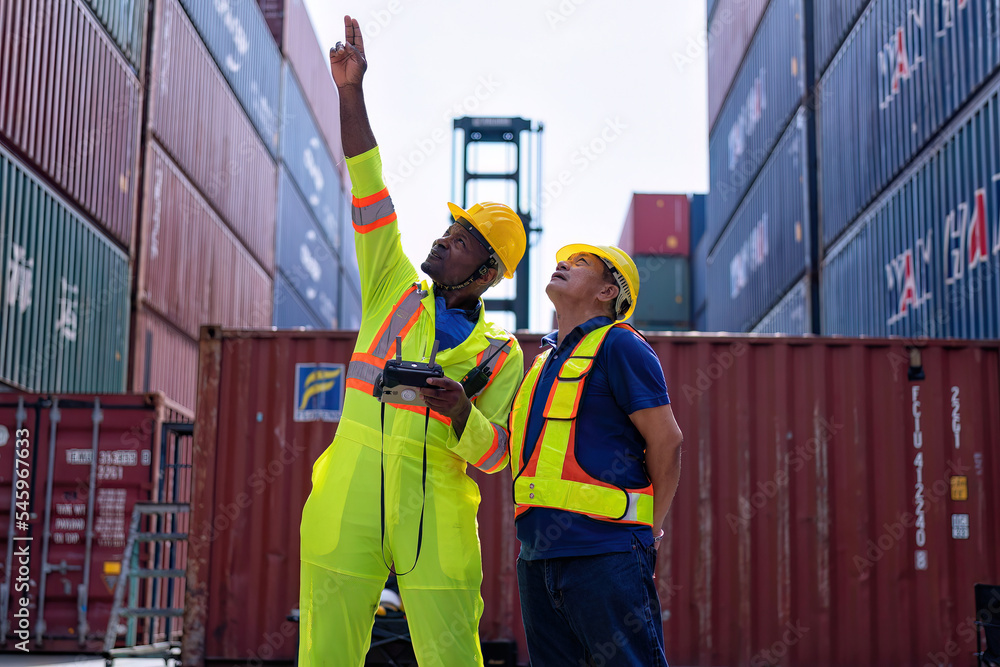 Engineer working in container storage yard fly drone looking top view ...